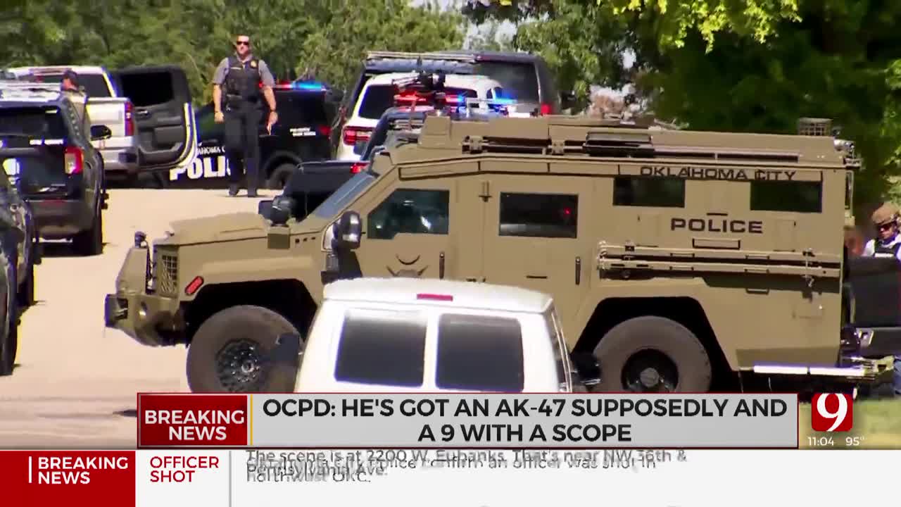 Police Load Injured Officer Into Squad Car After Being Involved In Shooting
